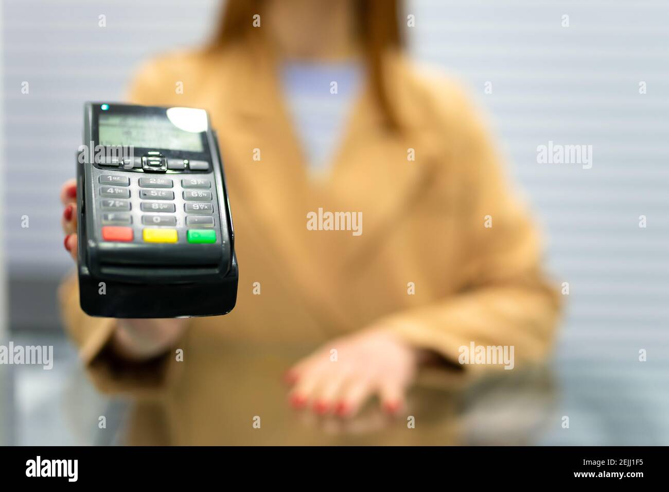 Woman gives payment terminal to client Stock Photo - Alamy