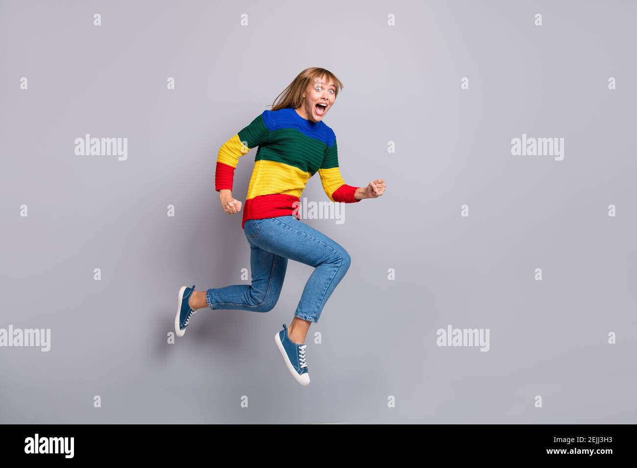 Full length body size photo of amazed girl jumping high running fast ...