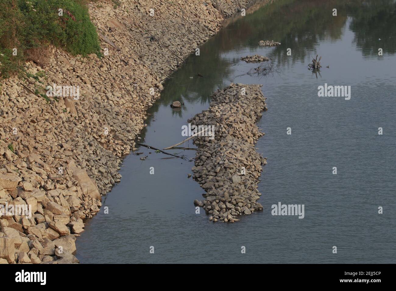 A villager walks in a dry Yom River during a drought season in Phichit ...