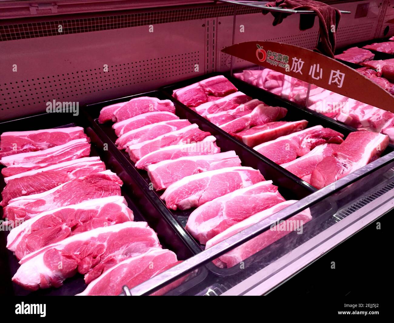 In this unlocated photo, pork awaits to be sold are displayed on ...