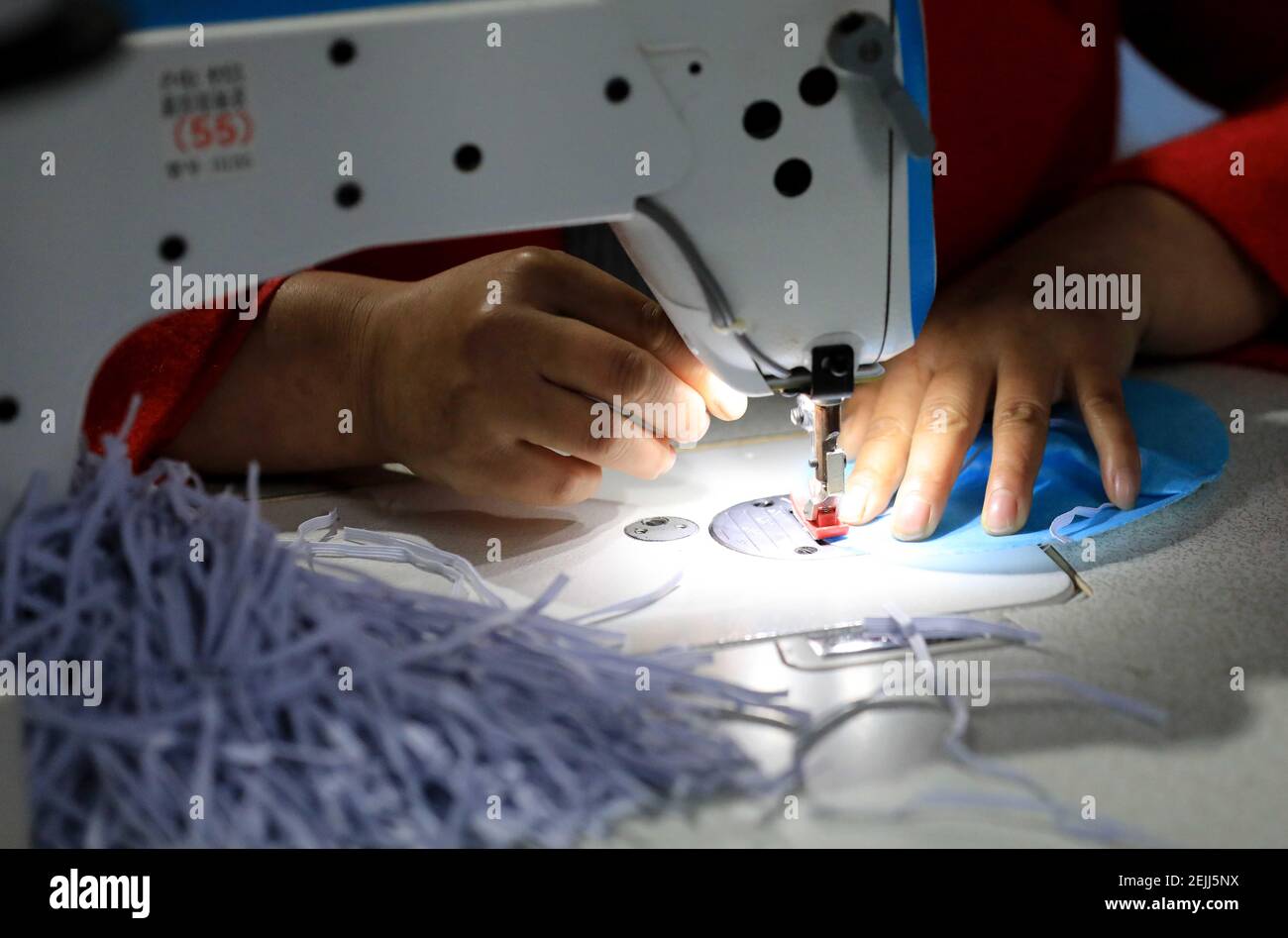 Chinese workers manufacture face masks at a factory during the outbreak ...