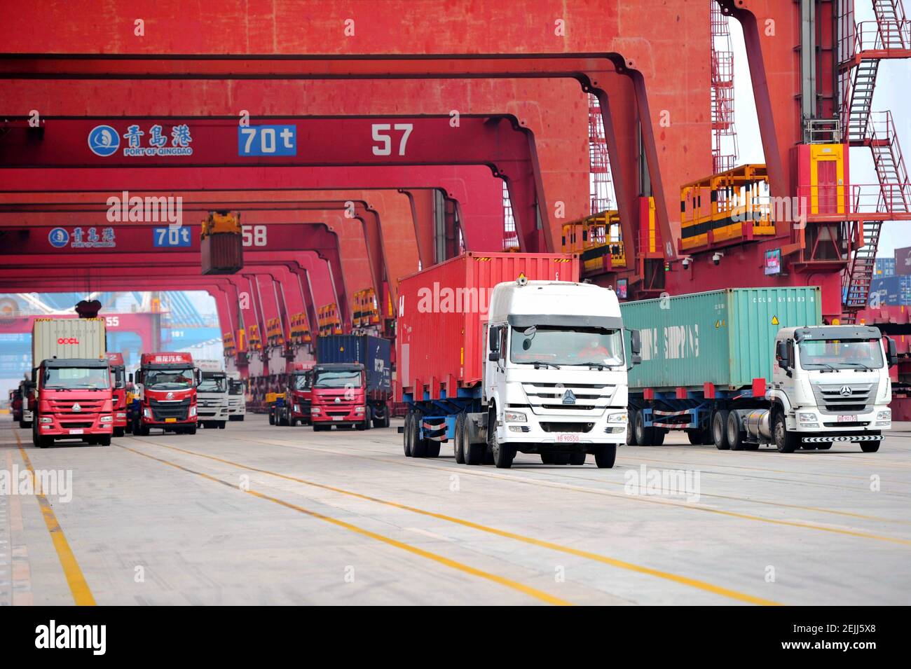 Trucks transport containers unloaded from a ship on a quay at the Port ...