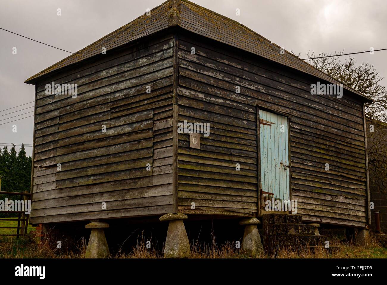 an old wooden farm out building perched on staddle stones Stock Photo ...