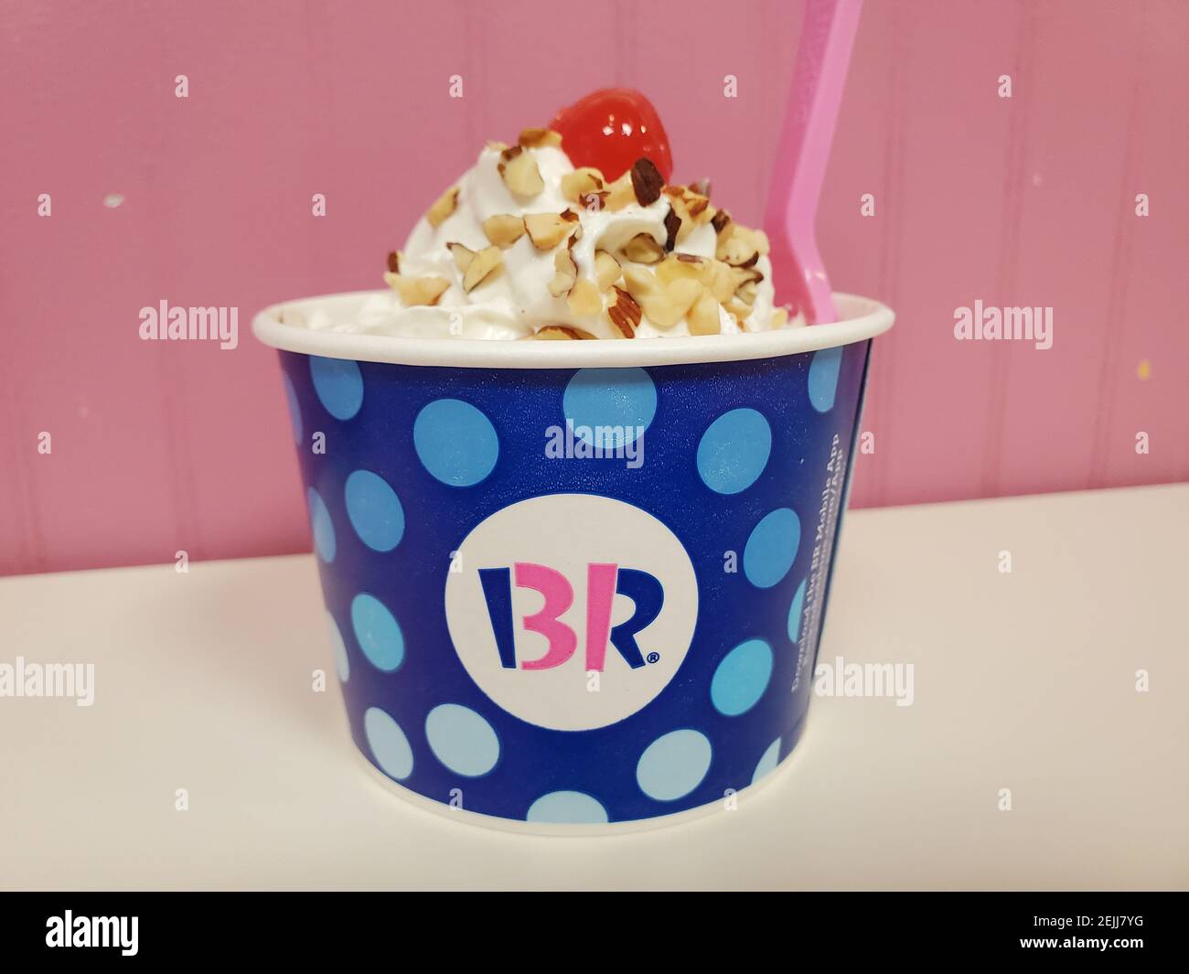 Baskin Robbins ice cream sundae on white surface against pink ...