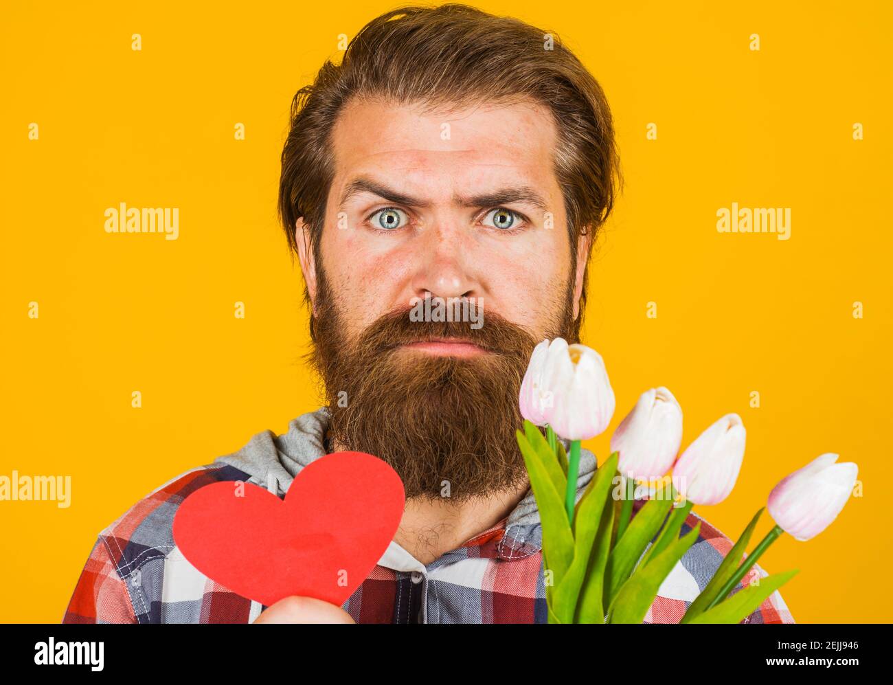 Valentines Day. Serious man with red heart and flowers. Valentine ...