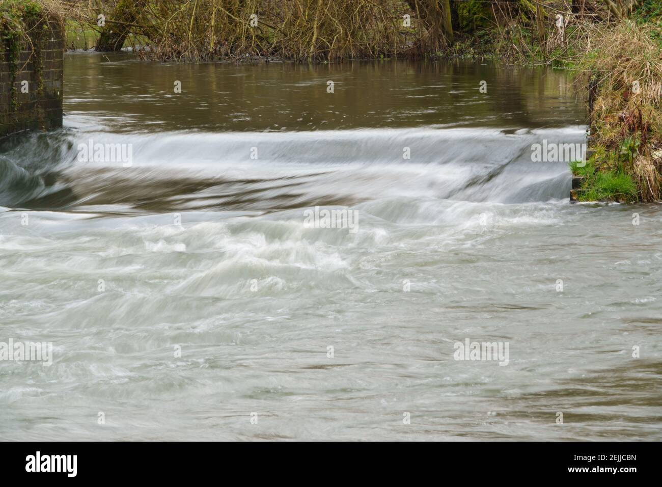 mill pond on the river avon with water cascading in a time-lapse blur ...
