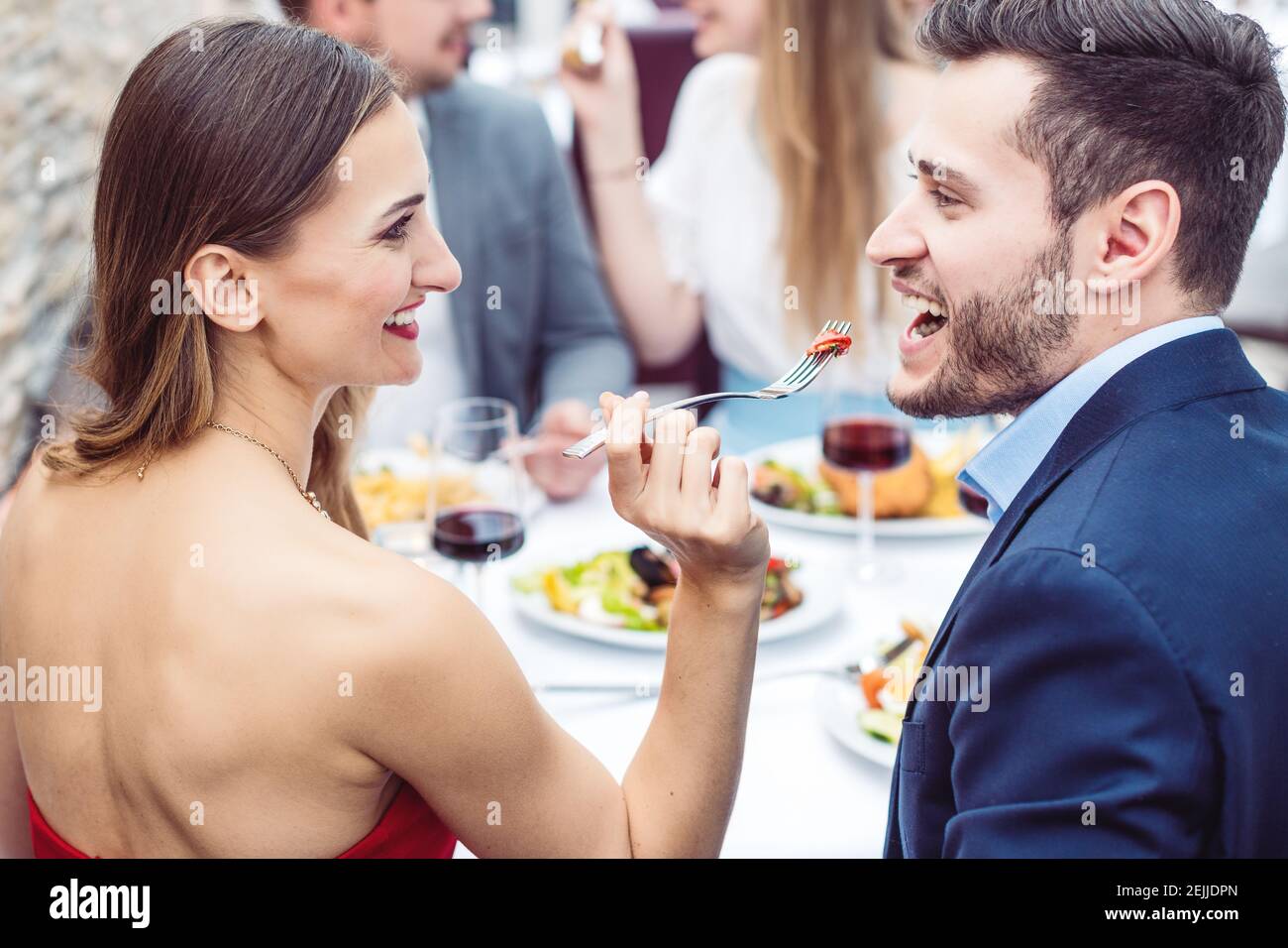 Woman feeding her man with Italian dishes in fancy restaurant Stock ...