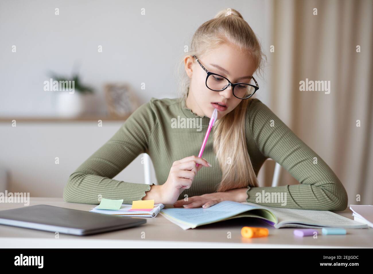 Concentrated school girl doing homework in her room Stock Photo - Alamy