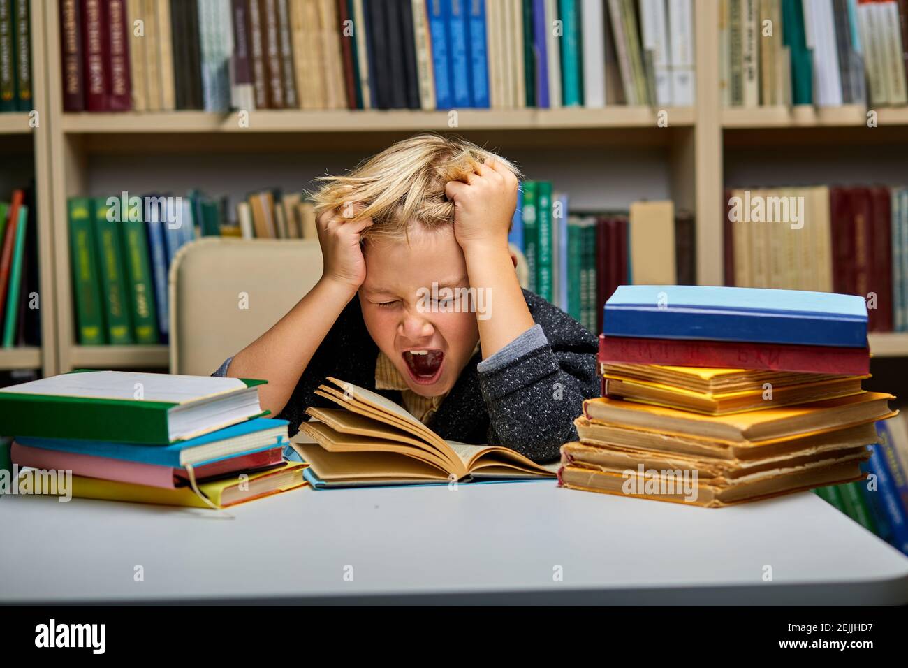 bored school boy scream, doesn't want to study, sits tired, want to go ...