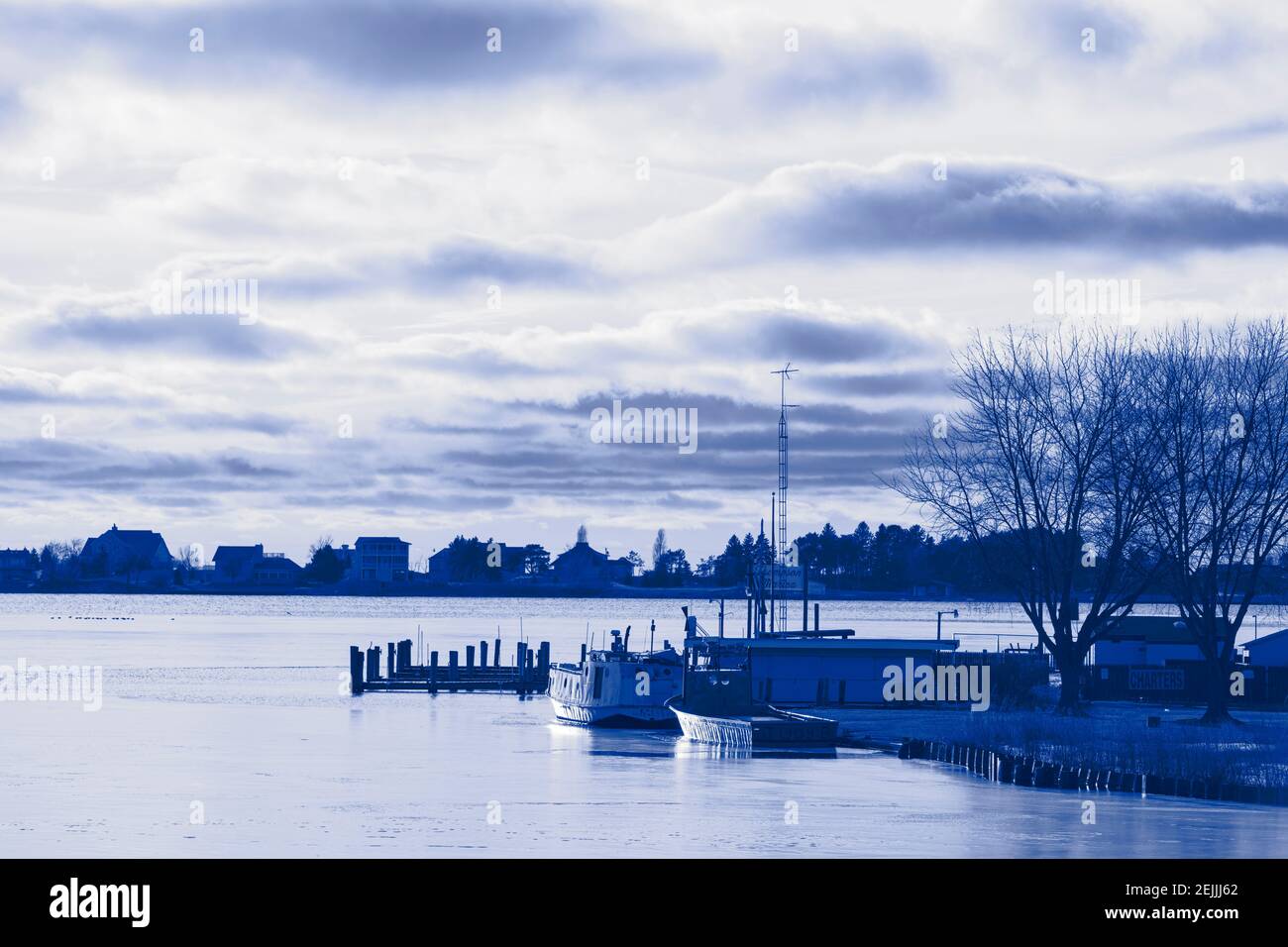 Commercial fishing vessels docked at marina in Pere Marquette Lake ...