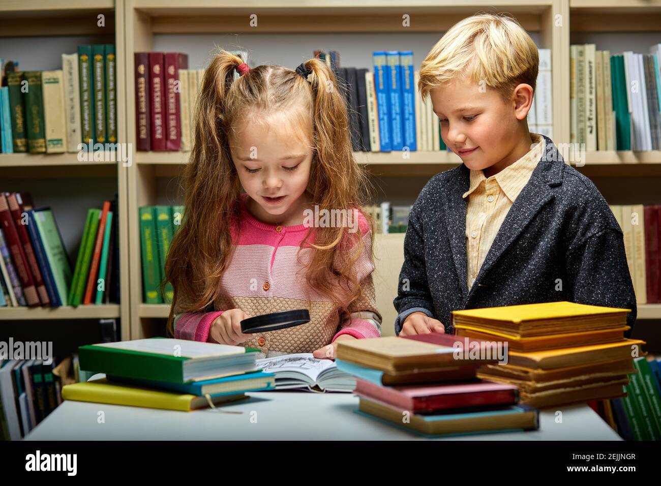 Two kids pile books hi-res stock photography and images - Alamy