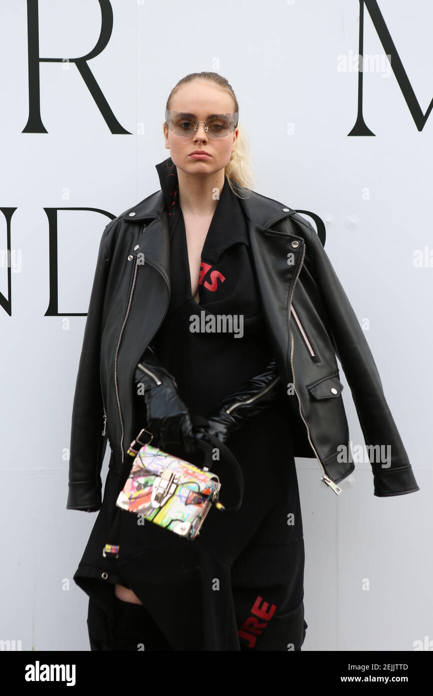 Stylish Lady wearing a black leather jacket while holding a colourful ...