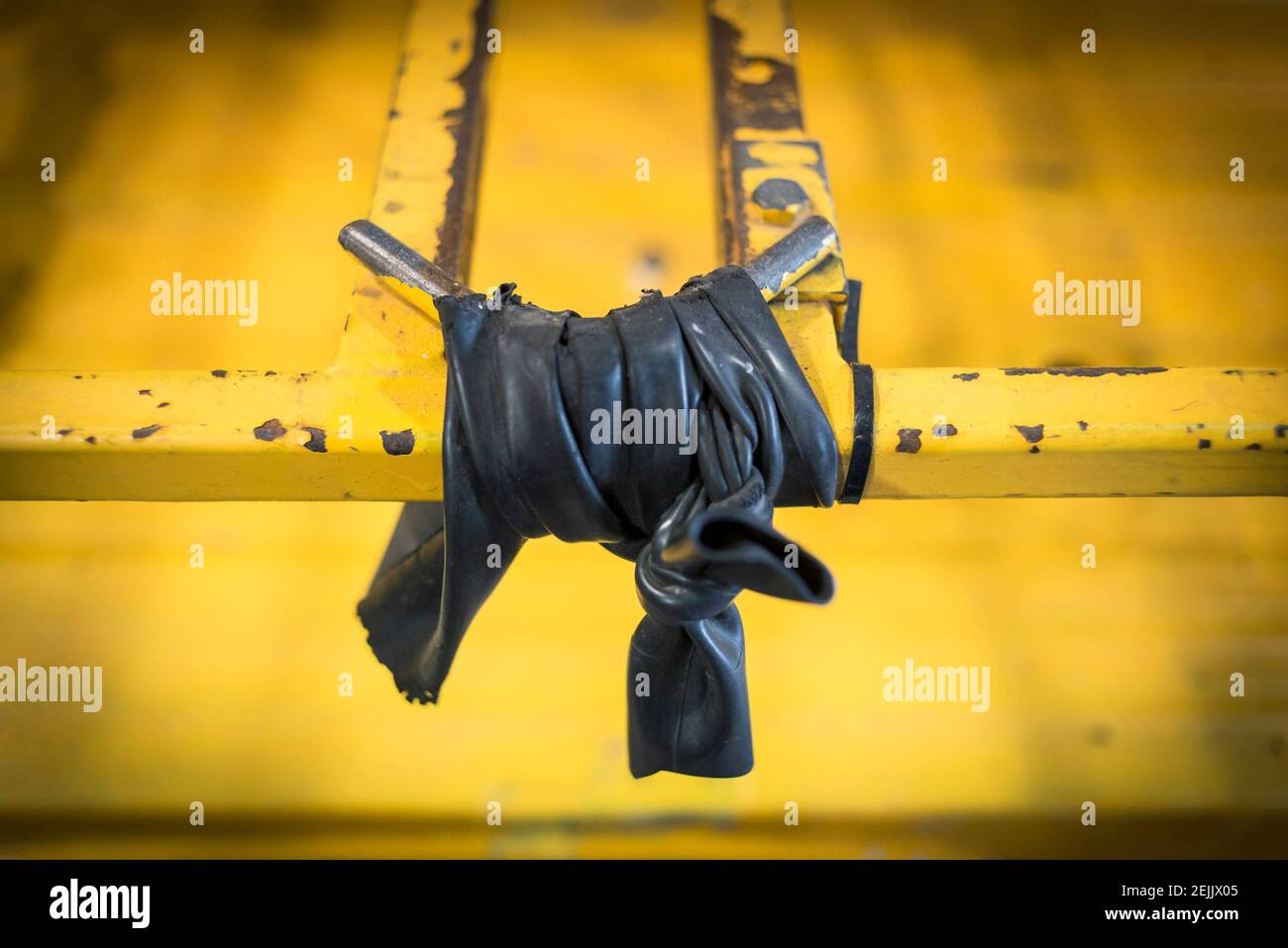 A pile of old bicycle inner tubes worn and stored read to be repurposed ...