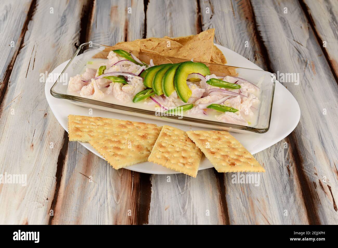 On a restaurant table a close-up of a Peruvian ceviche with avocado and ...