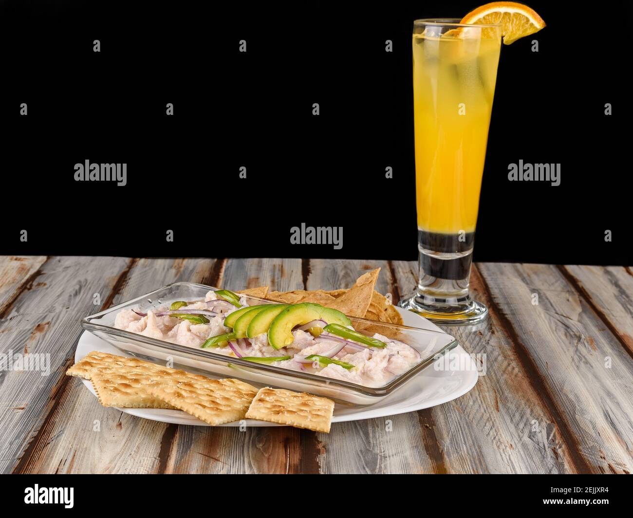 On a restaurant table a close-up of a Peruvian ceviche with avocado and ...