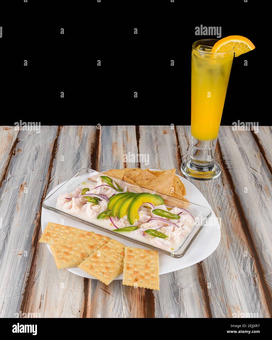 On a restaurant table a close-up of a Peruvian ceviche with avocado and ...