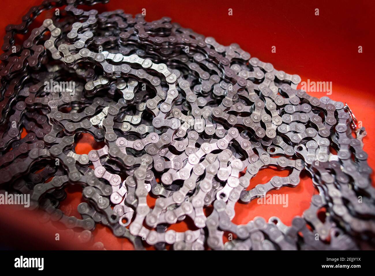 Loads of bike chains in a bike parts bin / washer Stock Photo - Alamy
