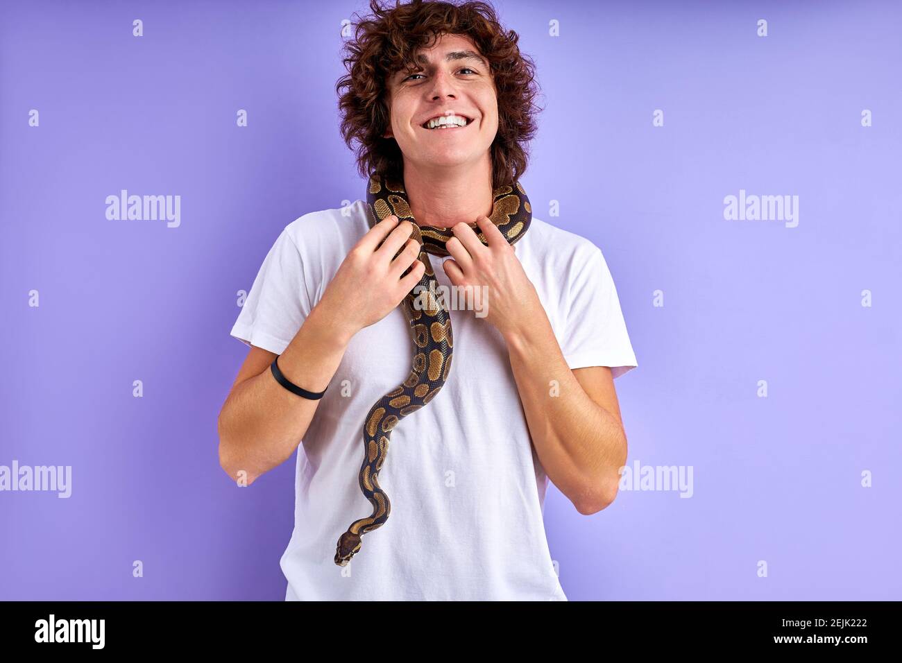 smiling guy stand brave with snake on him, caucasian male doesn't ...