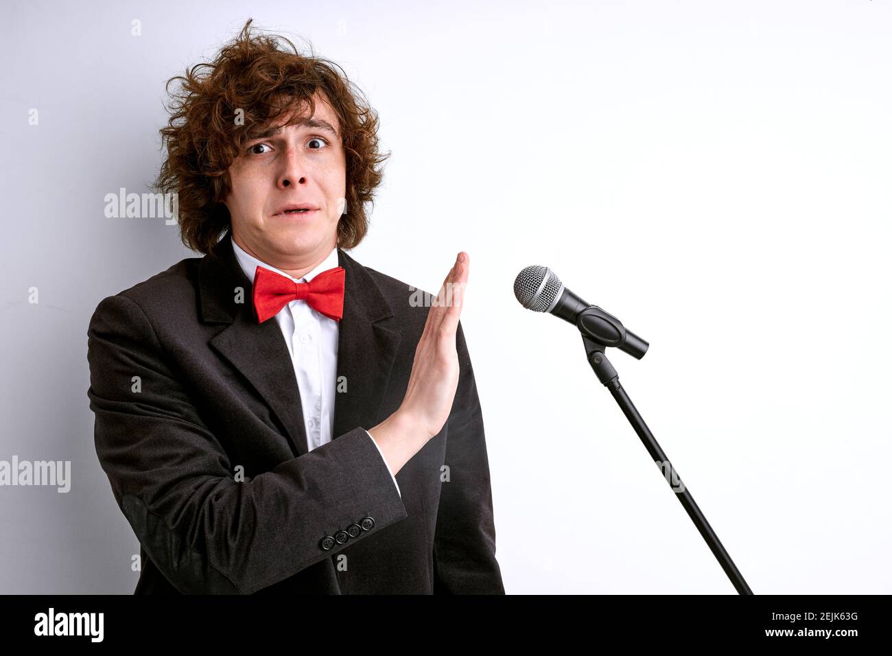 man refuses to speak, no need to say, stand near microphone. isolated ...