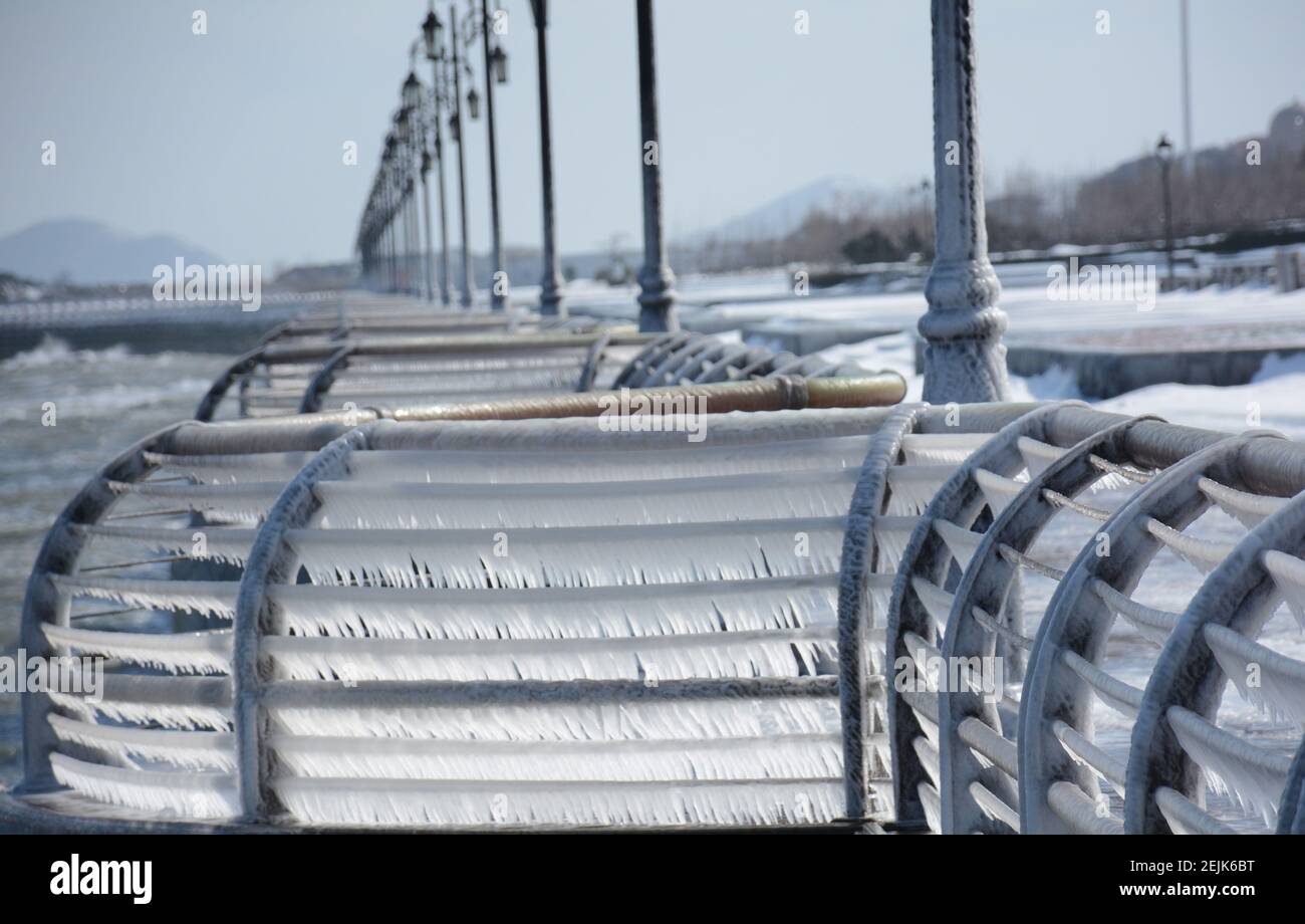 Due to gale and low temperature, ice appears and is hung at handrail at ...