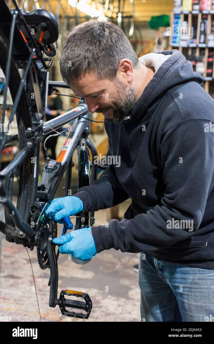 Mechanic works on bike hi-res stock photography and images - Alamy
