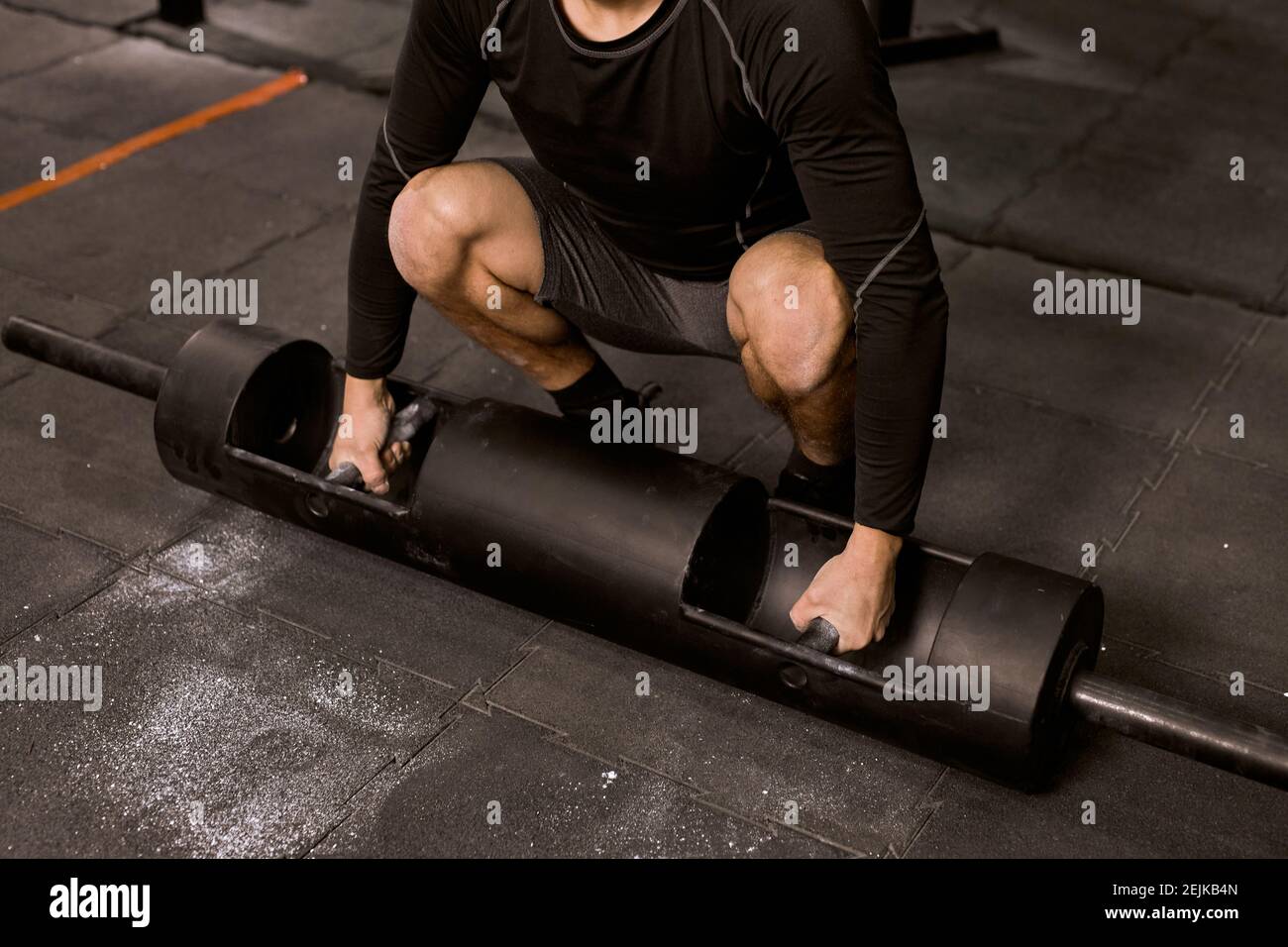 cropped muscular man raising heavy weights, training pumping arm ...