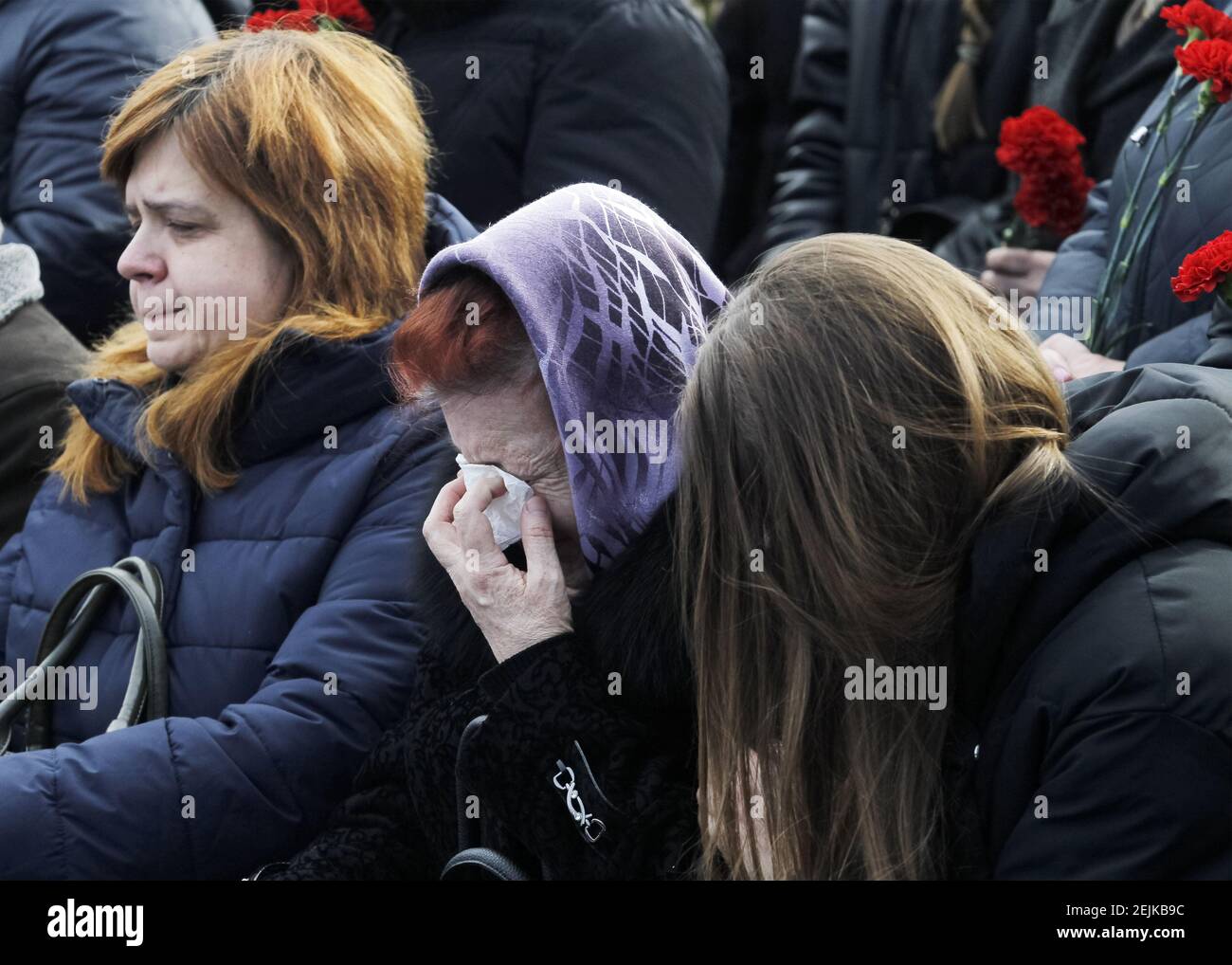 A woman reacts during a ceremony of founding a memorial to the victims ...