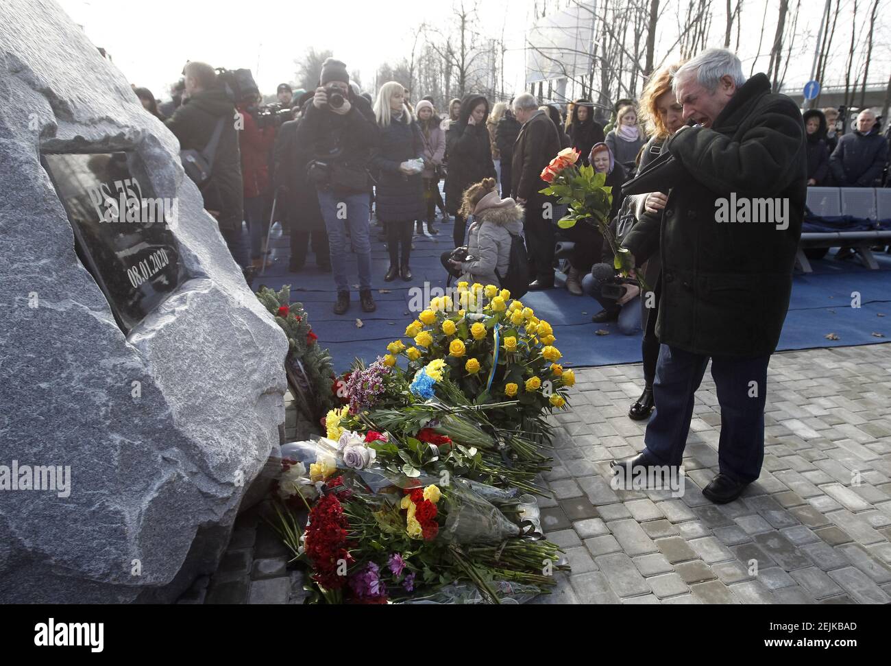 A relative reacts during a ceremony of founding a memorial to the ...