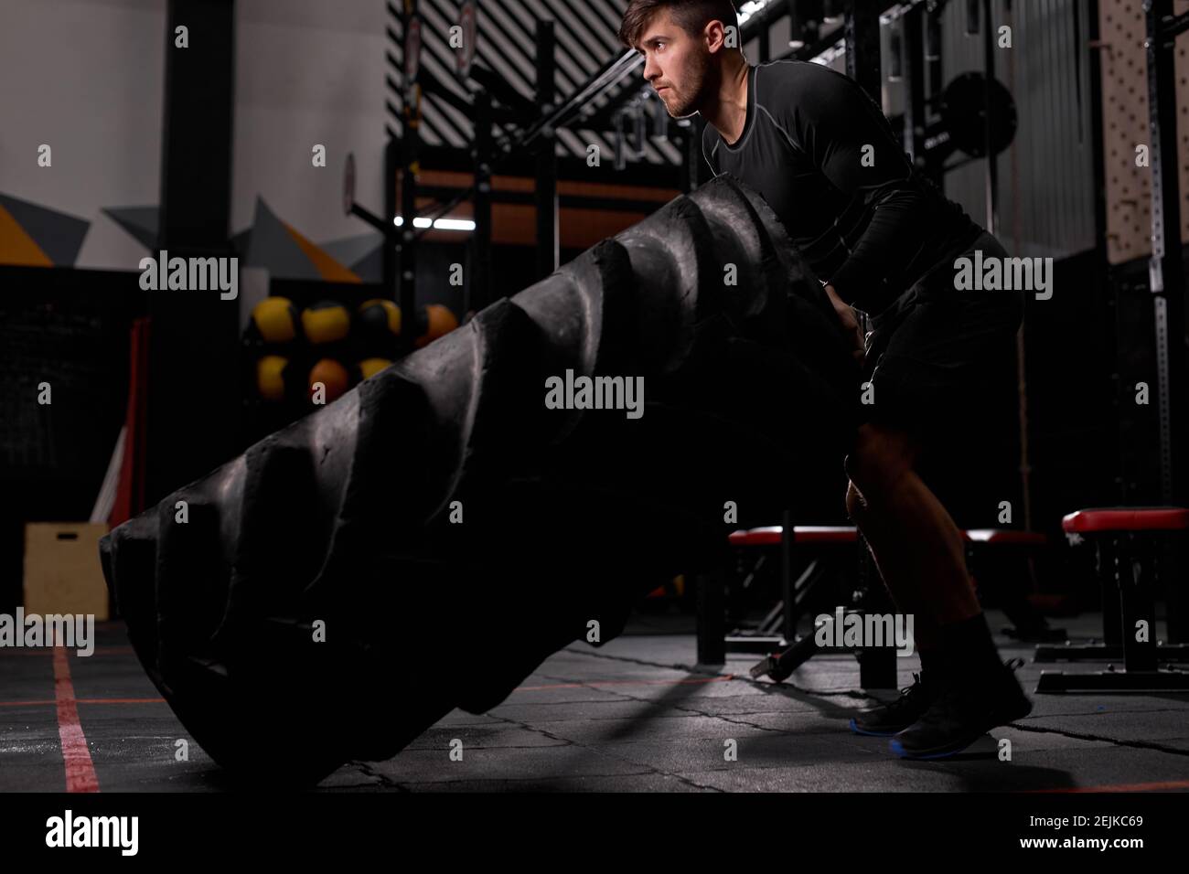 Sportsman turns tire, cross fit functional sport. Young caucasian guy ...