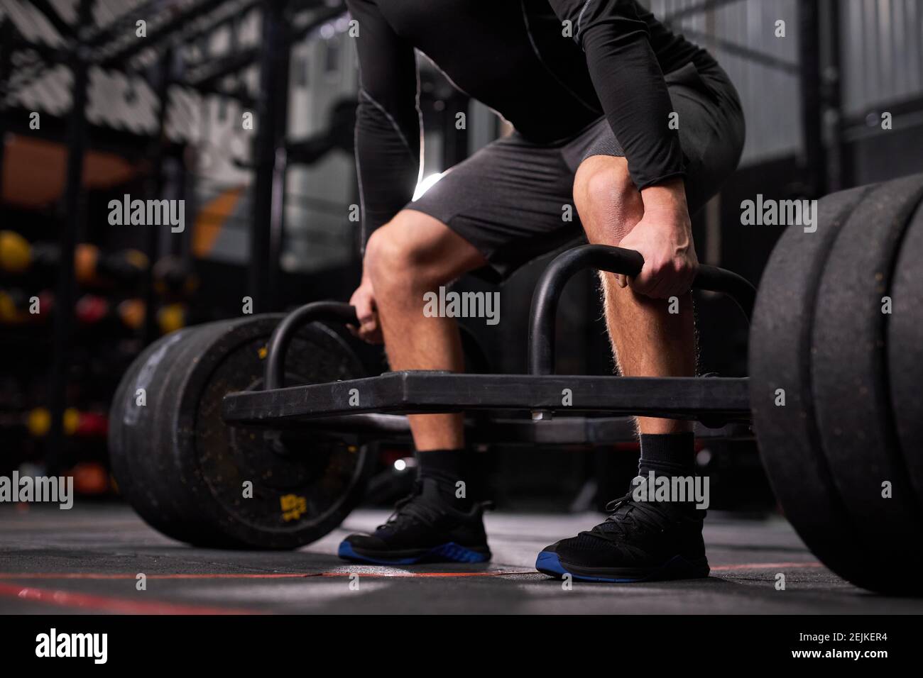 athlete man training with heavy weights at gym, handsome young ...