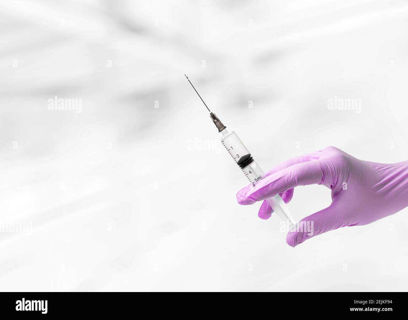 hand in a pink nitrile glove with a syringe for injection Stock Photo ...