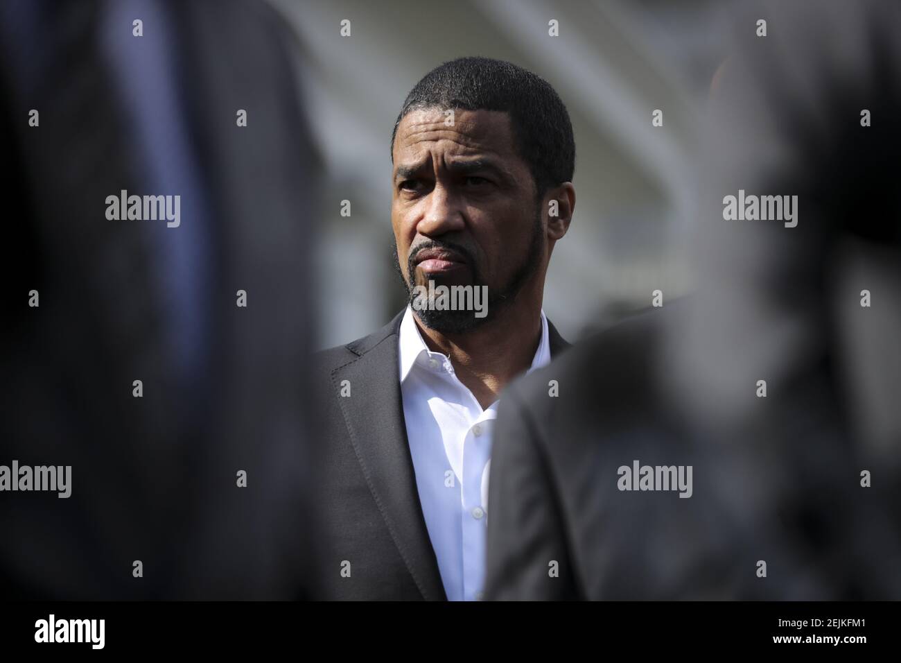 Pastor Darrell Scott listens to Former NFL football players after a ...