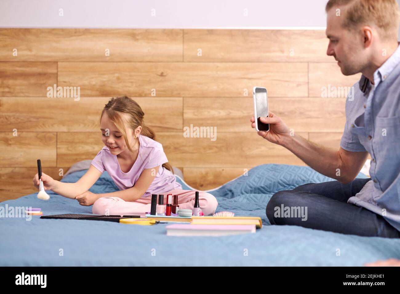 Young Dad Make Video On Mobile Phone Showing How His Daughter Doing