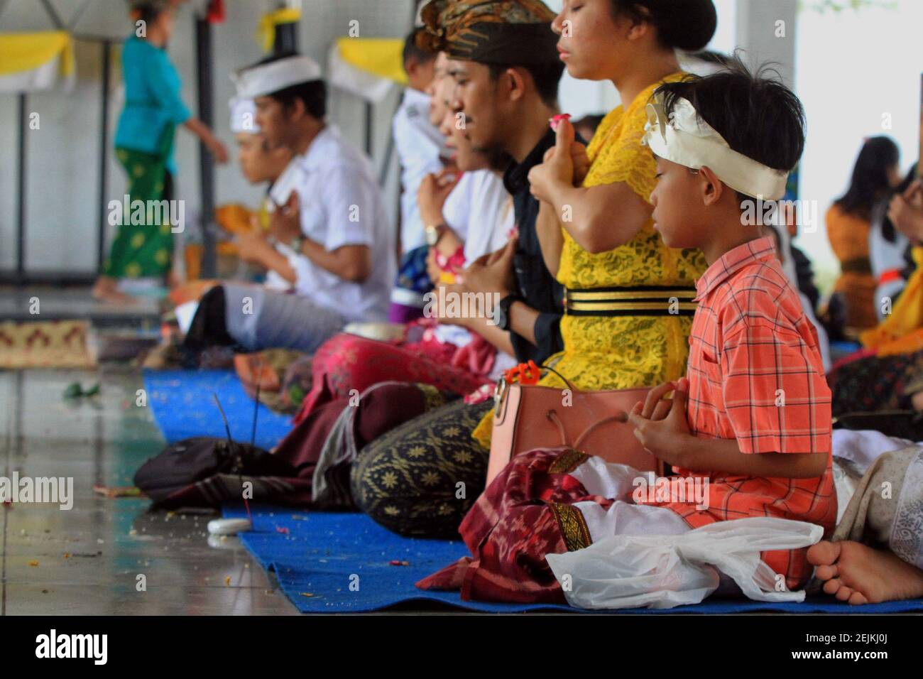 Javanese Balinese Hindus boy pray during the celebration of the ...