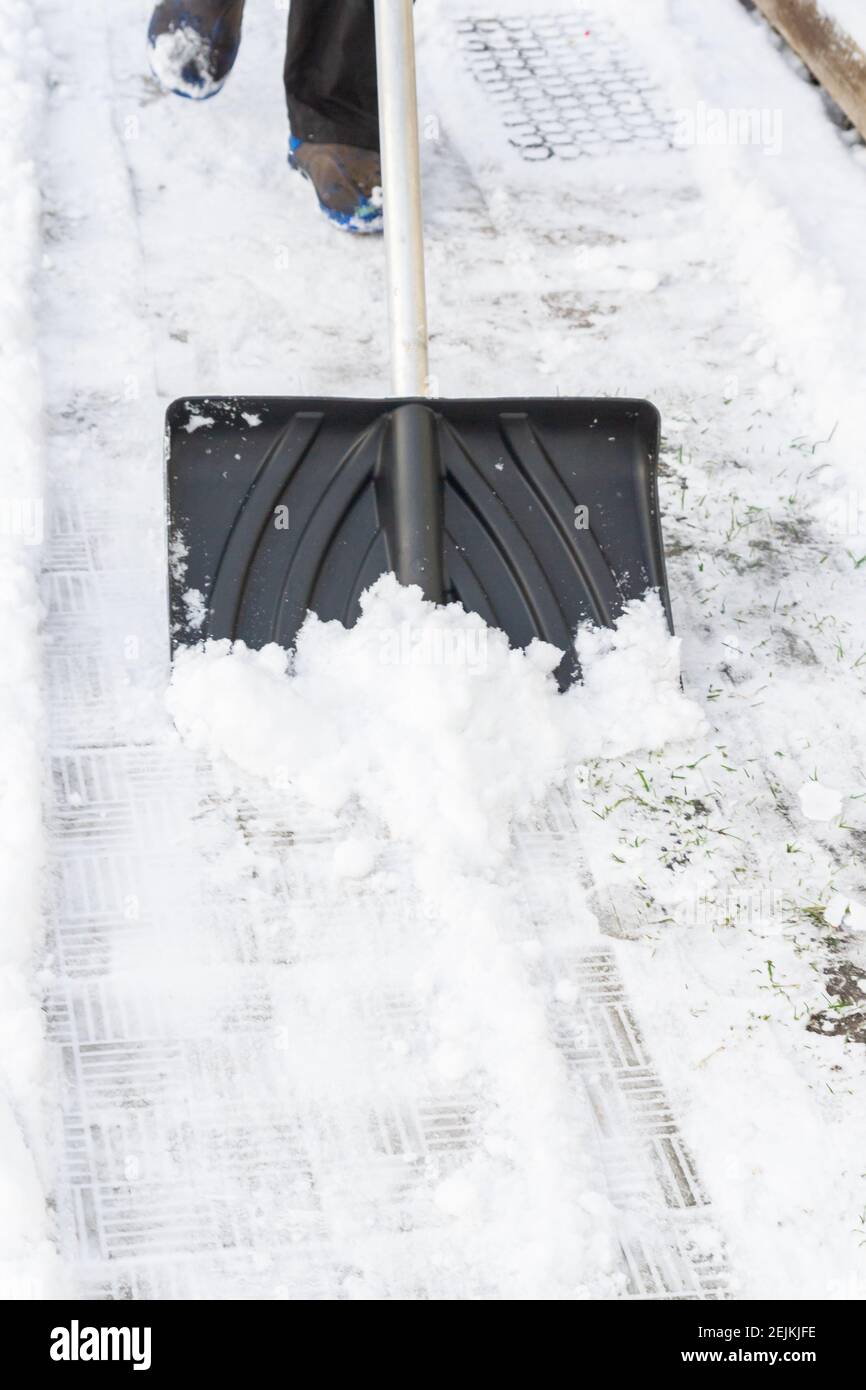 Snow cleaning with a large shovel in winter Stock Photo - Alamy