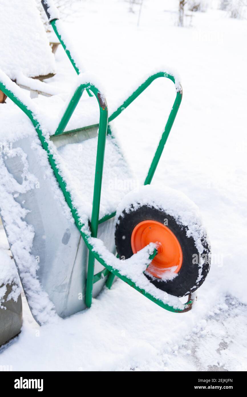Metal garden wheelbarrow in the snow in winter Stock Photo - Alamy