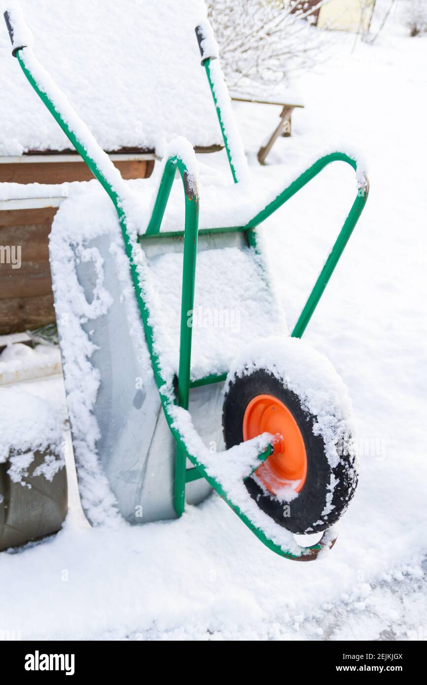 Metal garden wheelbarrow in the snow in winter Stock Photo - Alamy