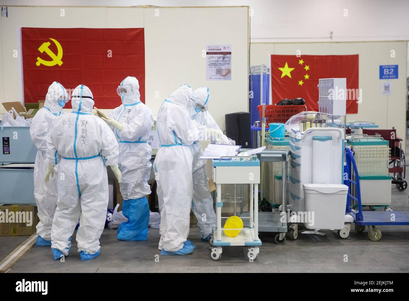 Well-equipped medical workers talk at a Fangcang mobile cabin hospital ...
