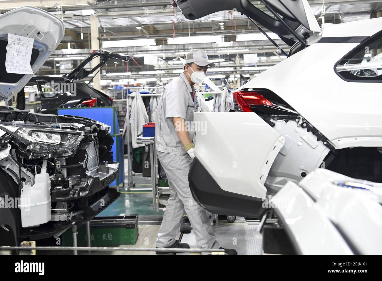 Chinese workers assemble Toyota SUVs on the assembly line at a plant of ...