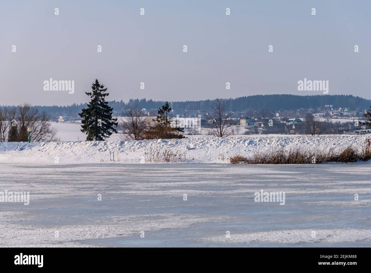 Snow-covered village near the field in winter Stock Photo - Alamy
