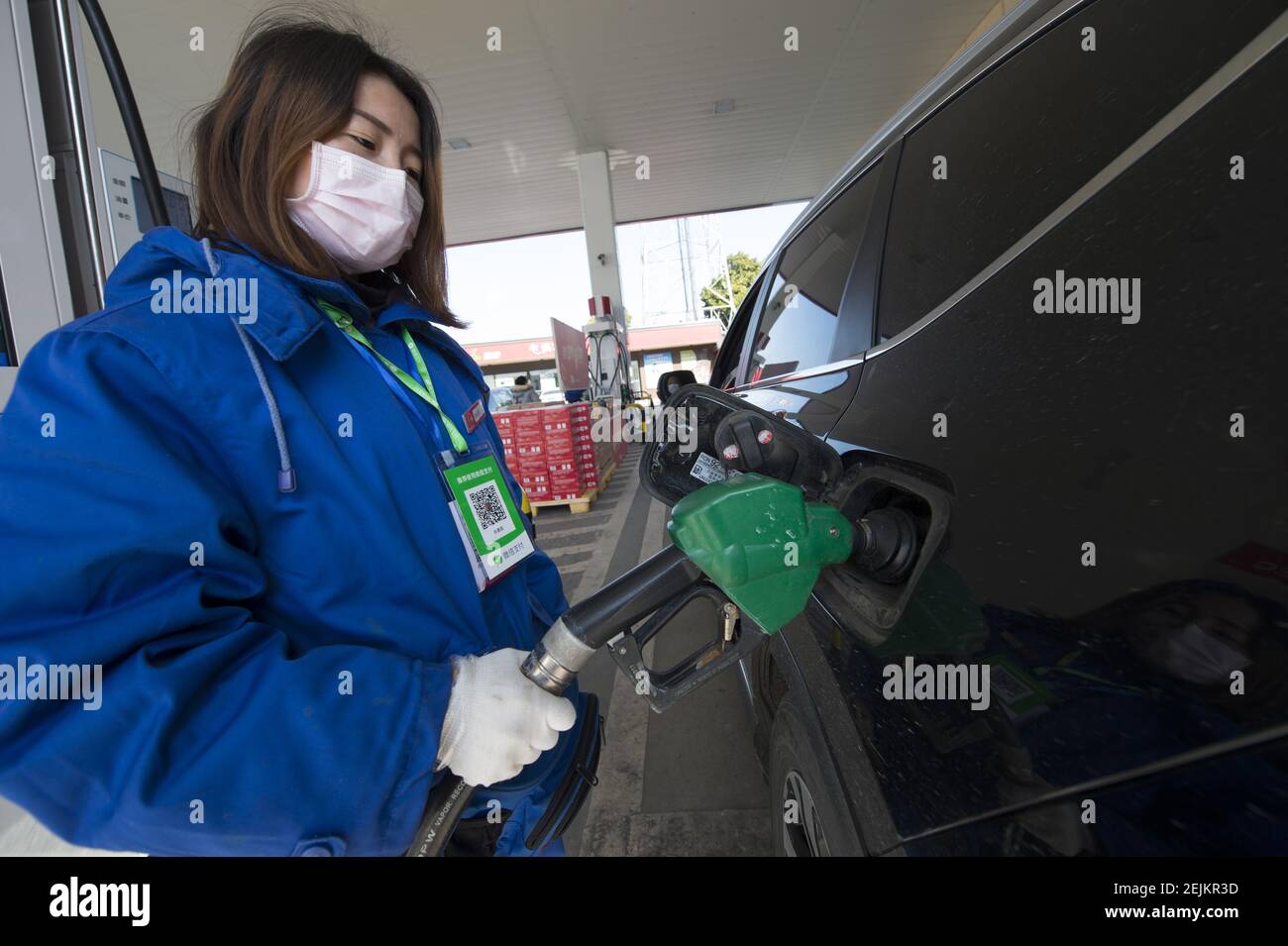 A Chinese worker refuels car at a gas station of Sinopec in Hai'an City ...
