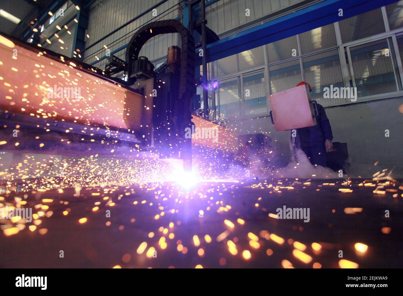 A work uses electric drills at a factory in Yangzhou city, east China's ...
