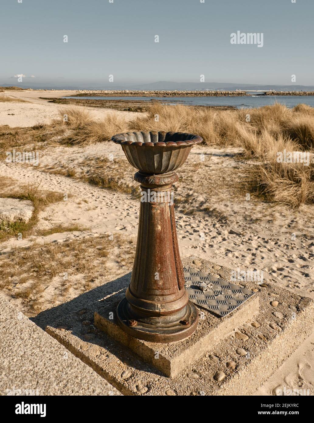 Vertical shot of an ancient rusty pillar on the coast Stock Photo - Alamy