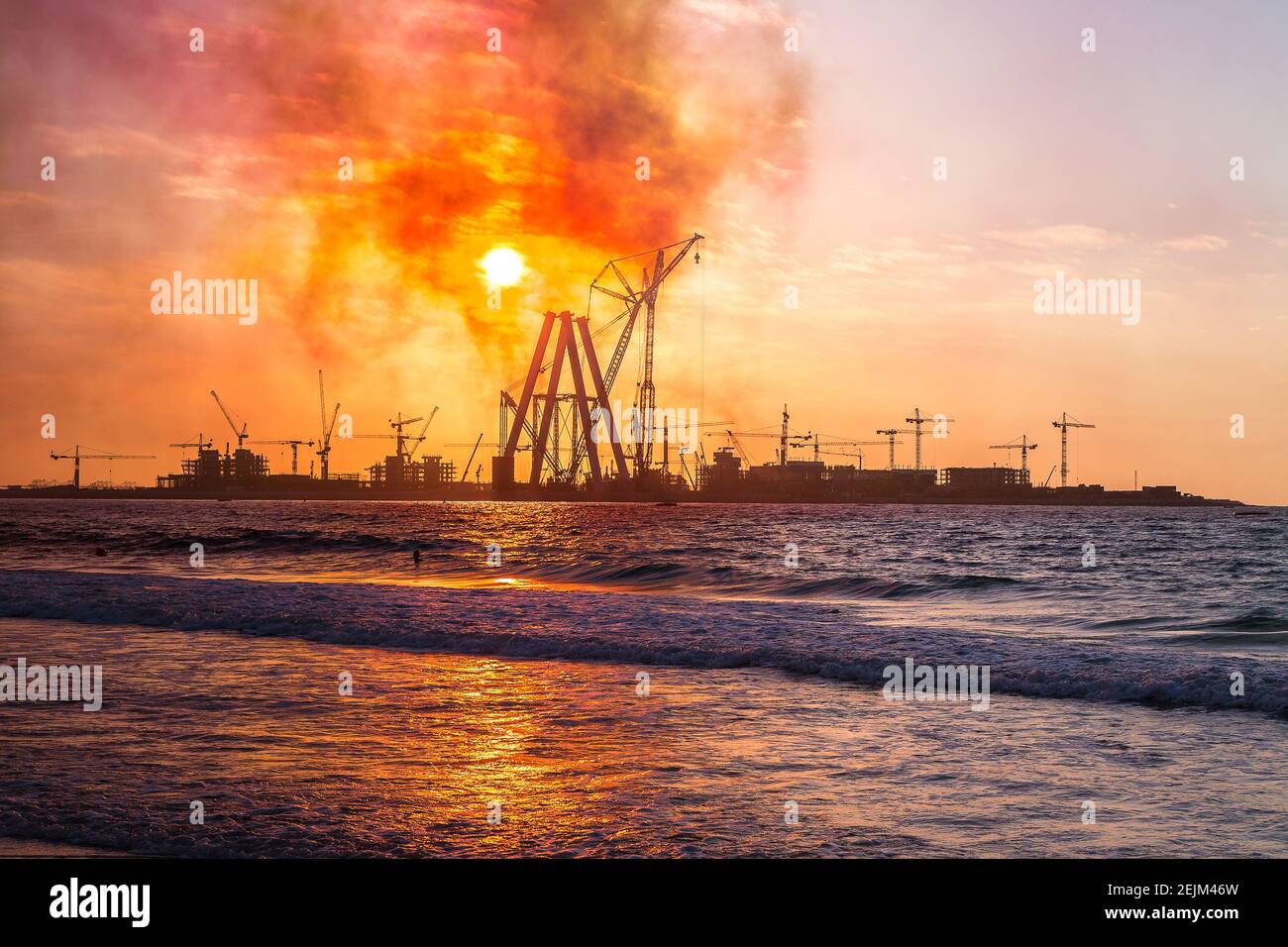 Construction site in Dubai at the sea sunset Stock Photo - Alamy