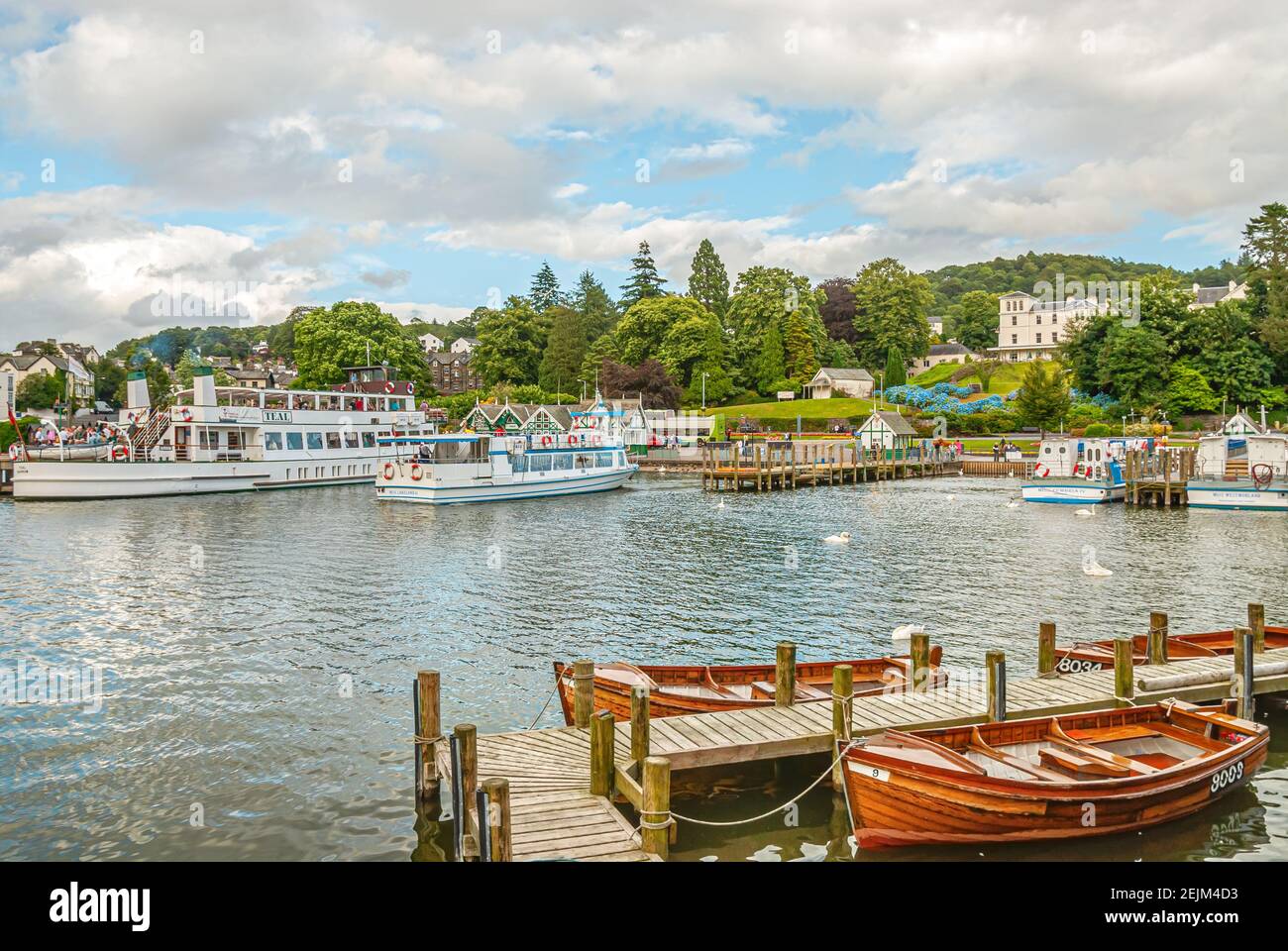 Sightseeing ship and rowing boats at the harbour of Windermere at Lake ...