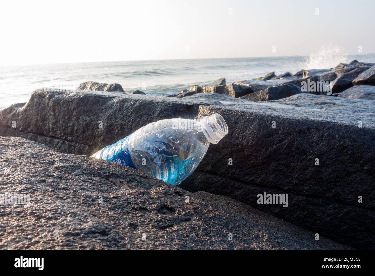 Plastic pollution with single use plastic bottles and other junk left ...
