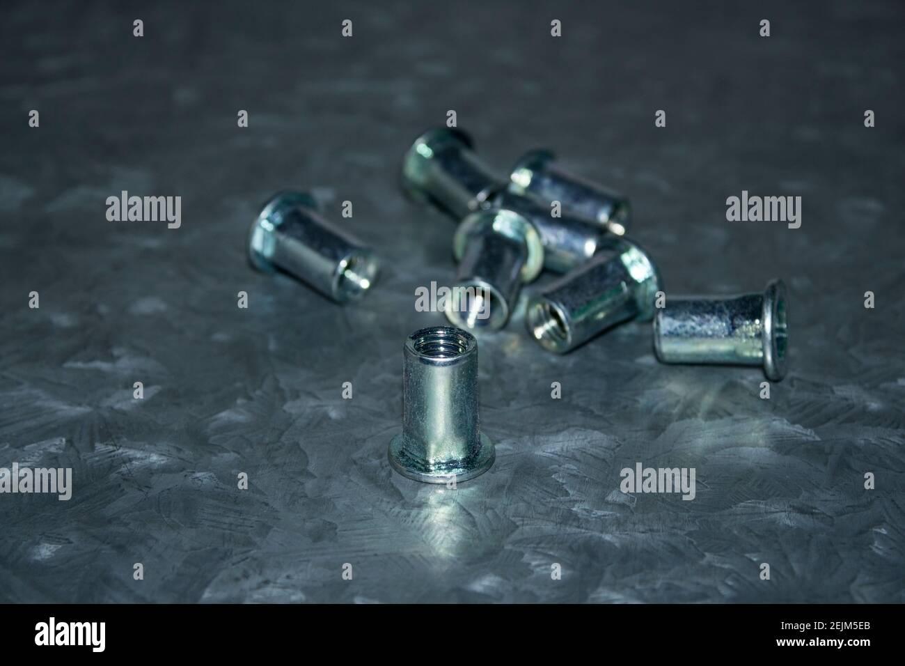 A few industrial blind rivets on a galvanized metal sheet Stock Photo ...