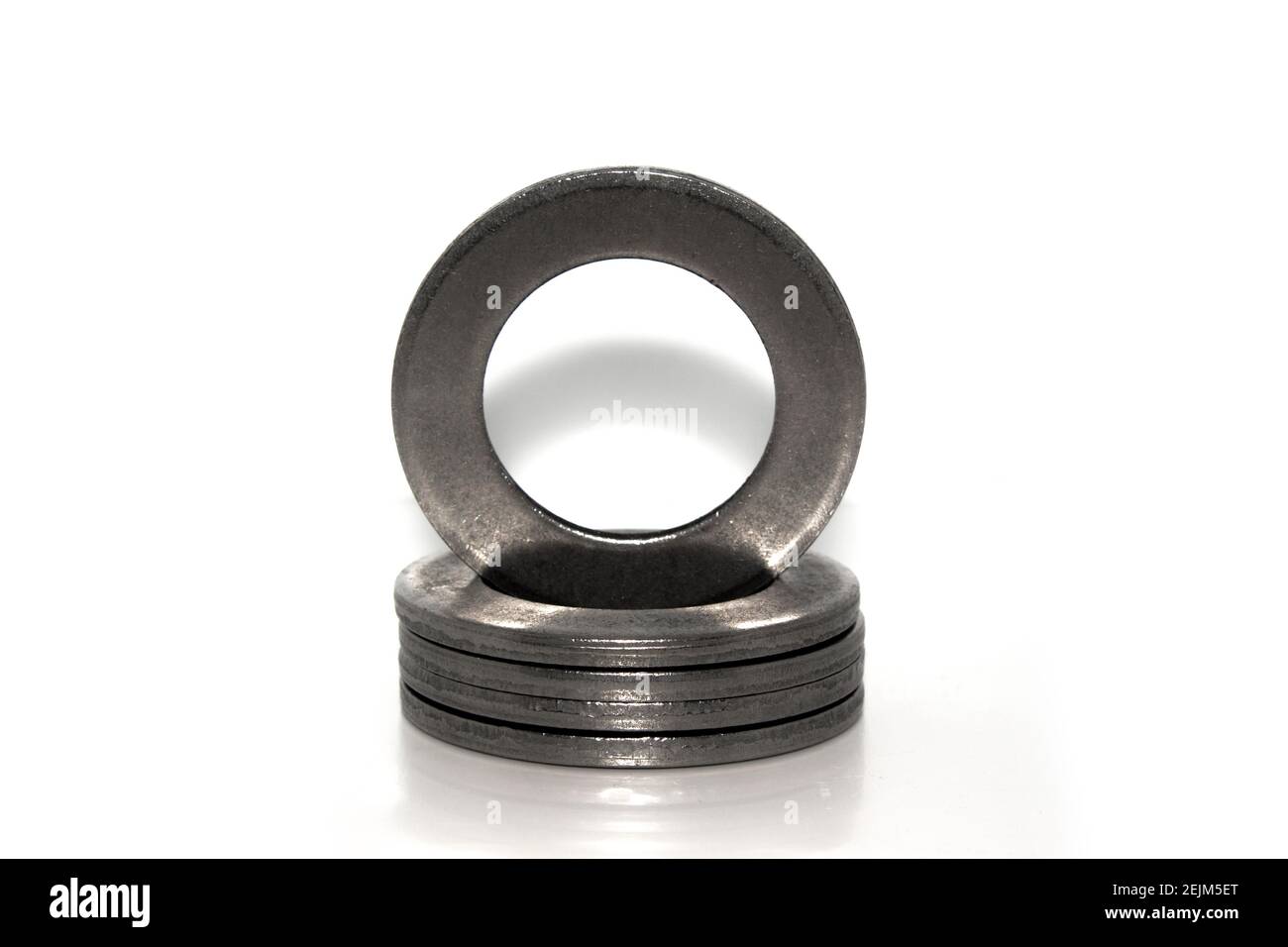 A few big industrial galvanized steel washers on white background Stock ...