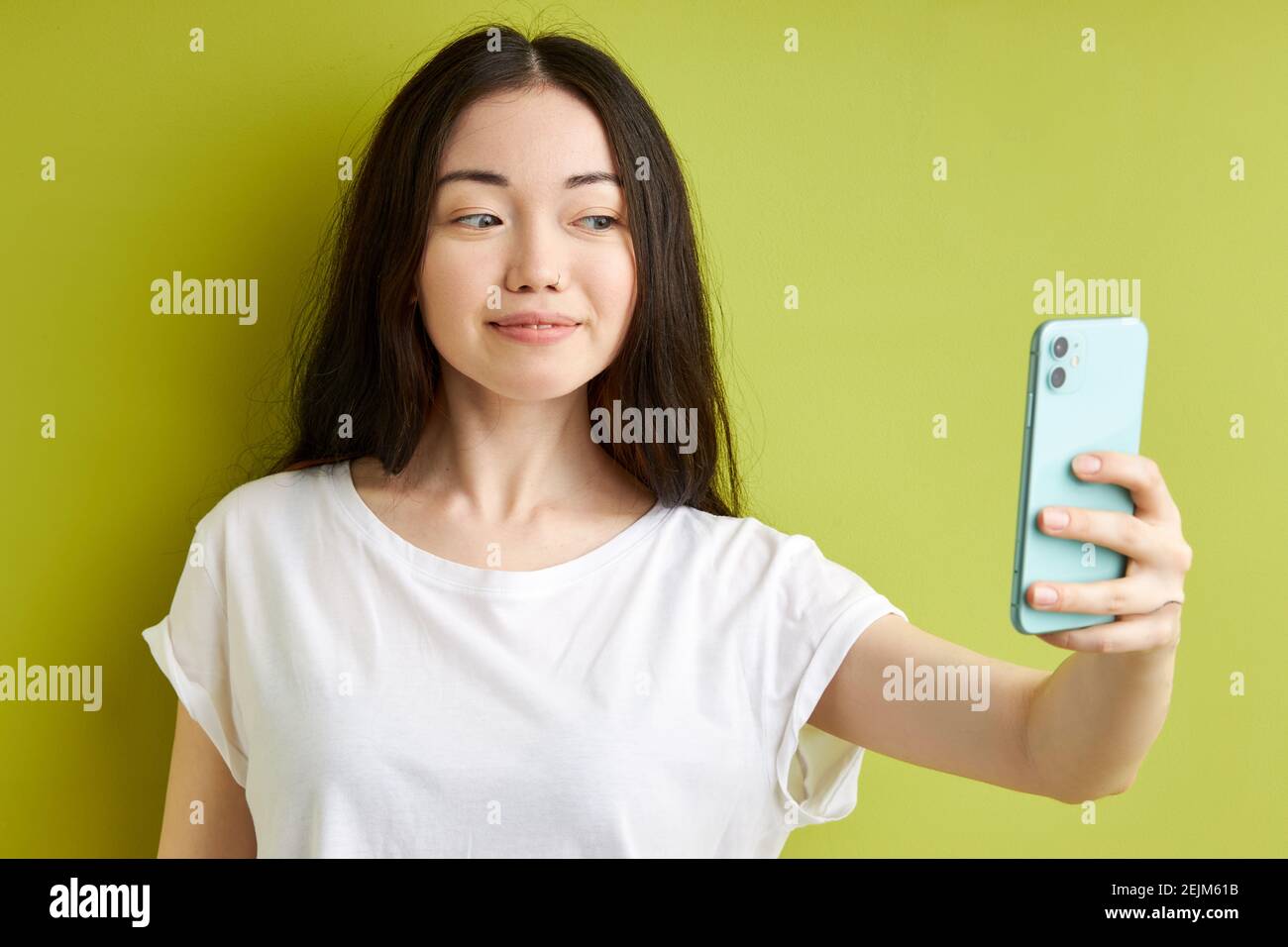 woman make selfie on smartphone, posing at phone's camera isolated over ...
