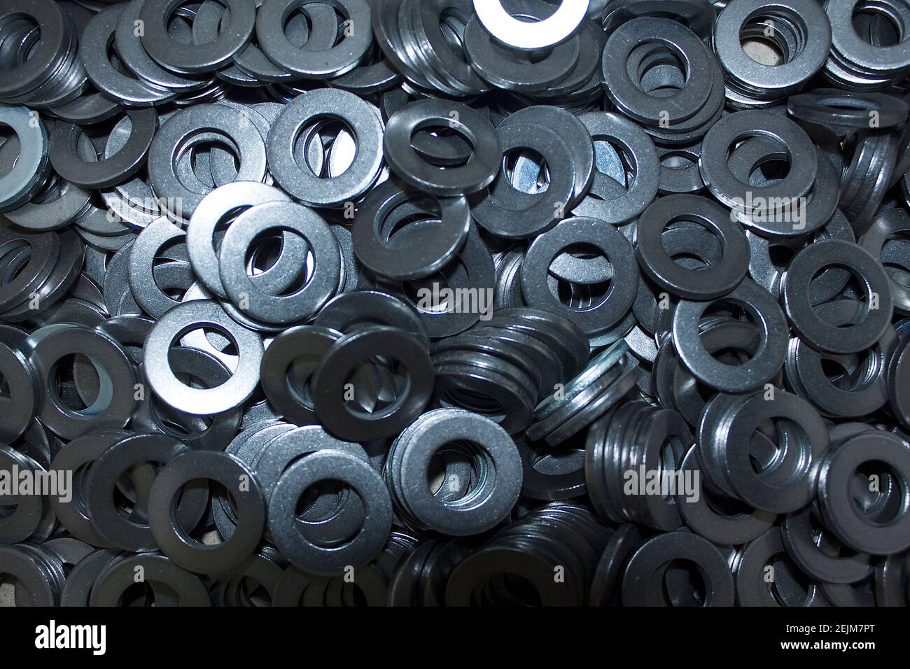 Lots of big industrial steel washers on a pile Stock Photo - Alamy